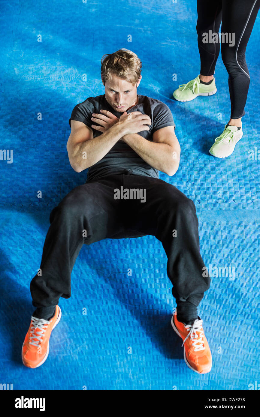 High angle view of man doing sit-ups at gym Stock Photo - Alamy
