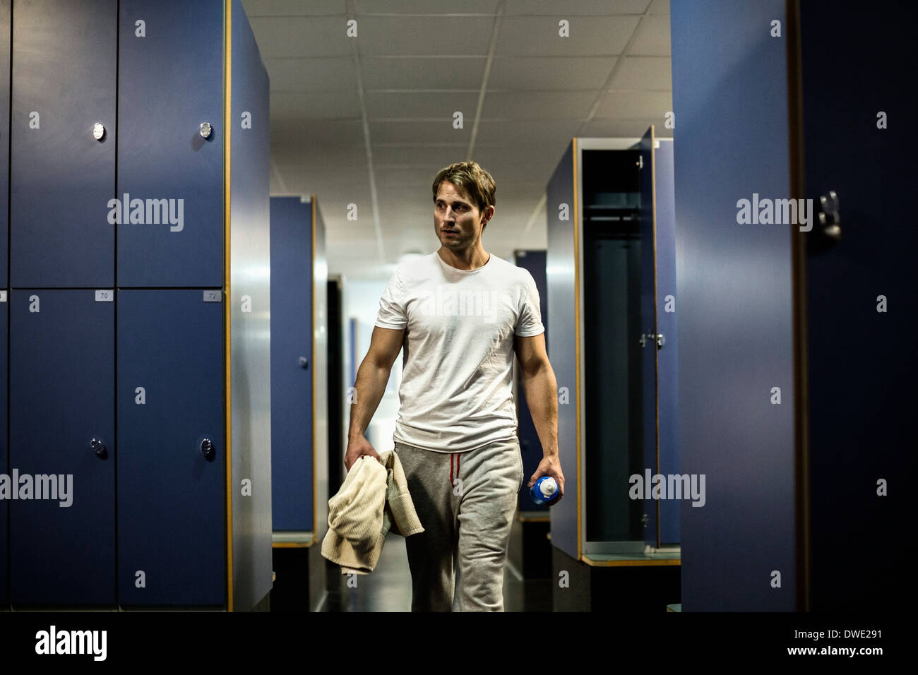 Man walking in locker room of health club Stock Photo - Alamy