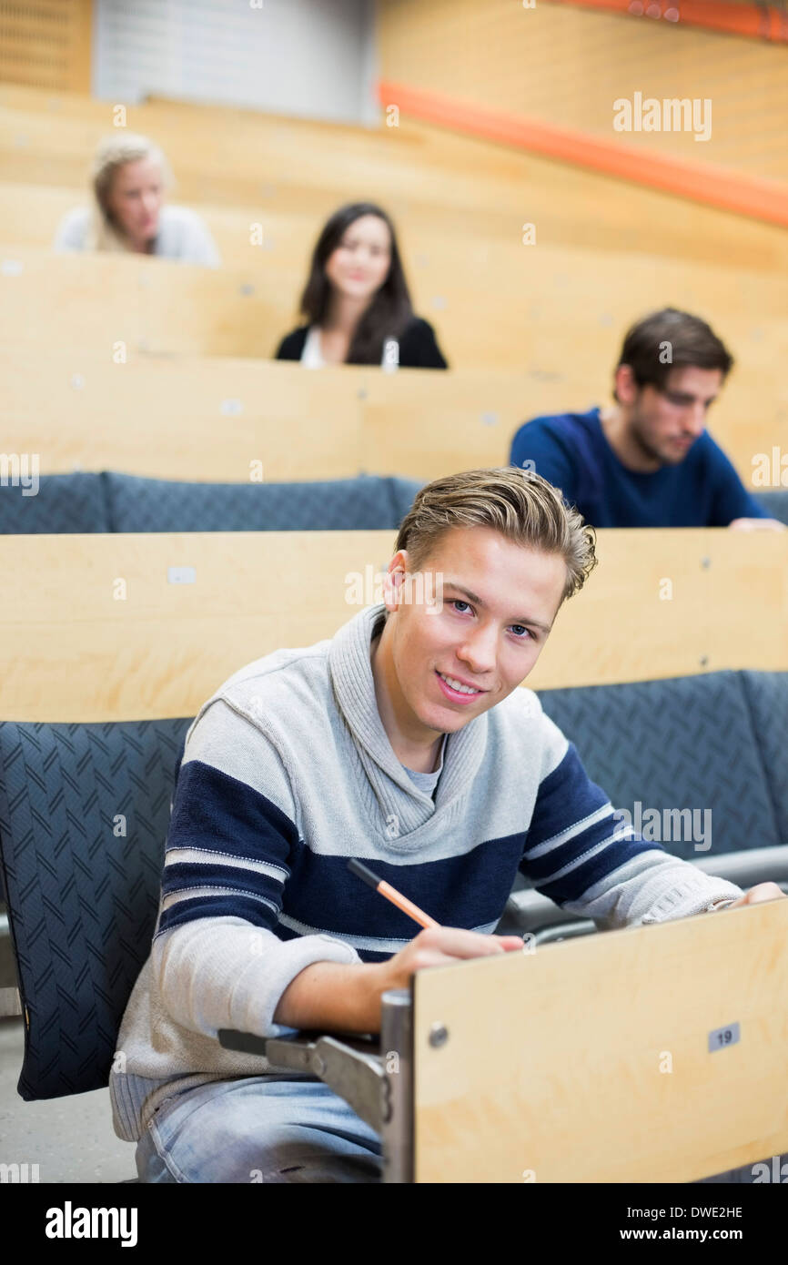 Portrait of confident university student studying in classroom Stock ...