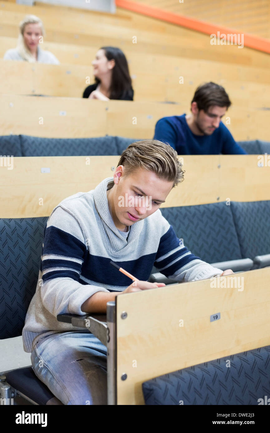 Male student studying in classroom Stock Photo - Alamy