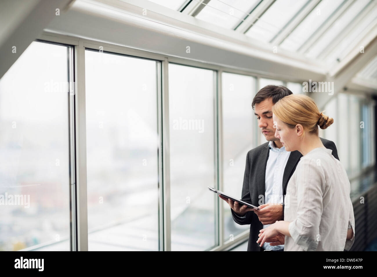 Business people standing together tablet hi-res stock photography and ...