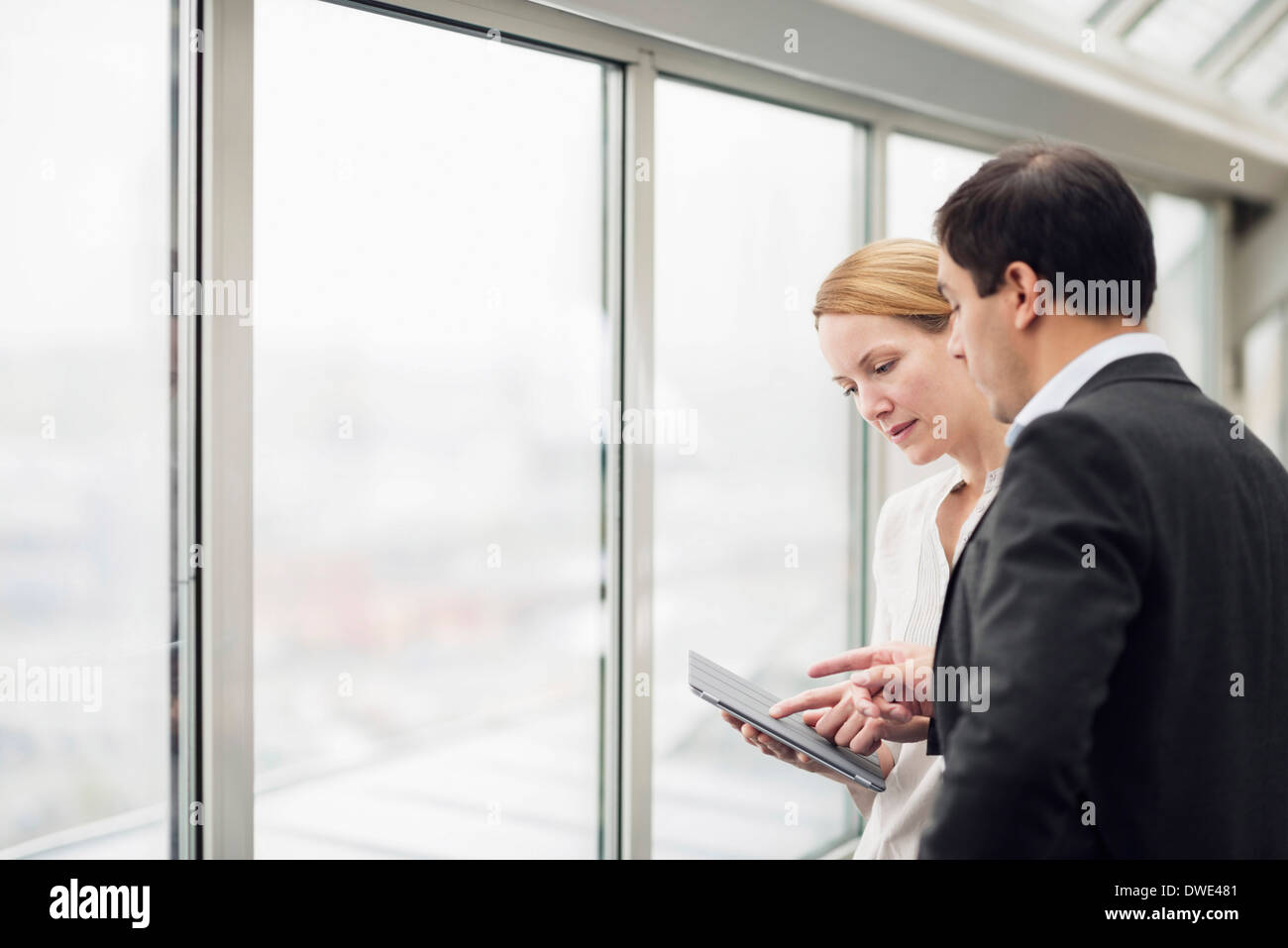 Business people using tablet together hi-res stock photography and ...