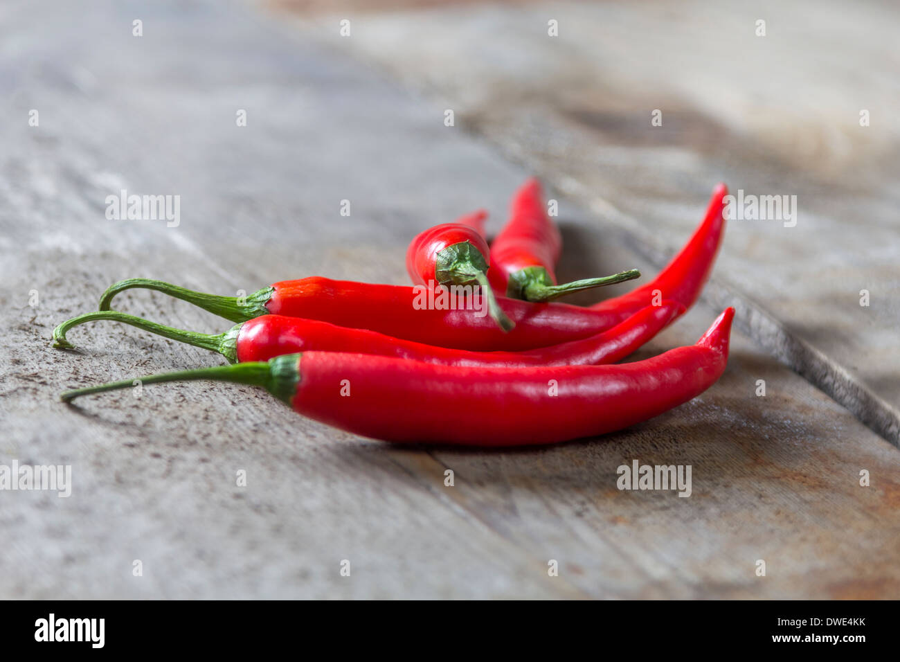 bunch of red chillies on rustic wooden background Stock Photo - Alamy