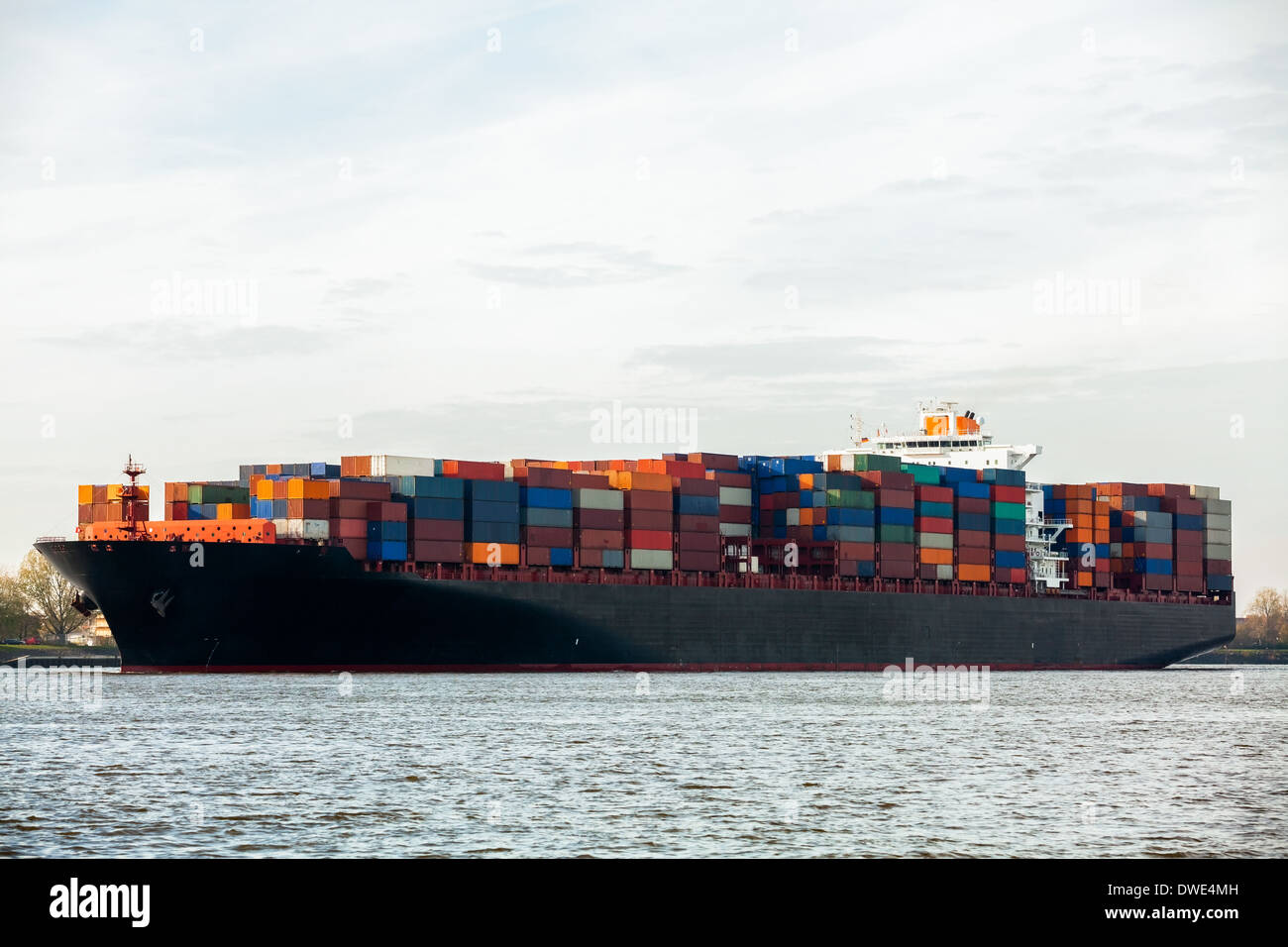 Fully laden container ship in port with its decks stacked with metal ...
