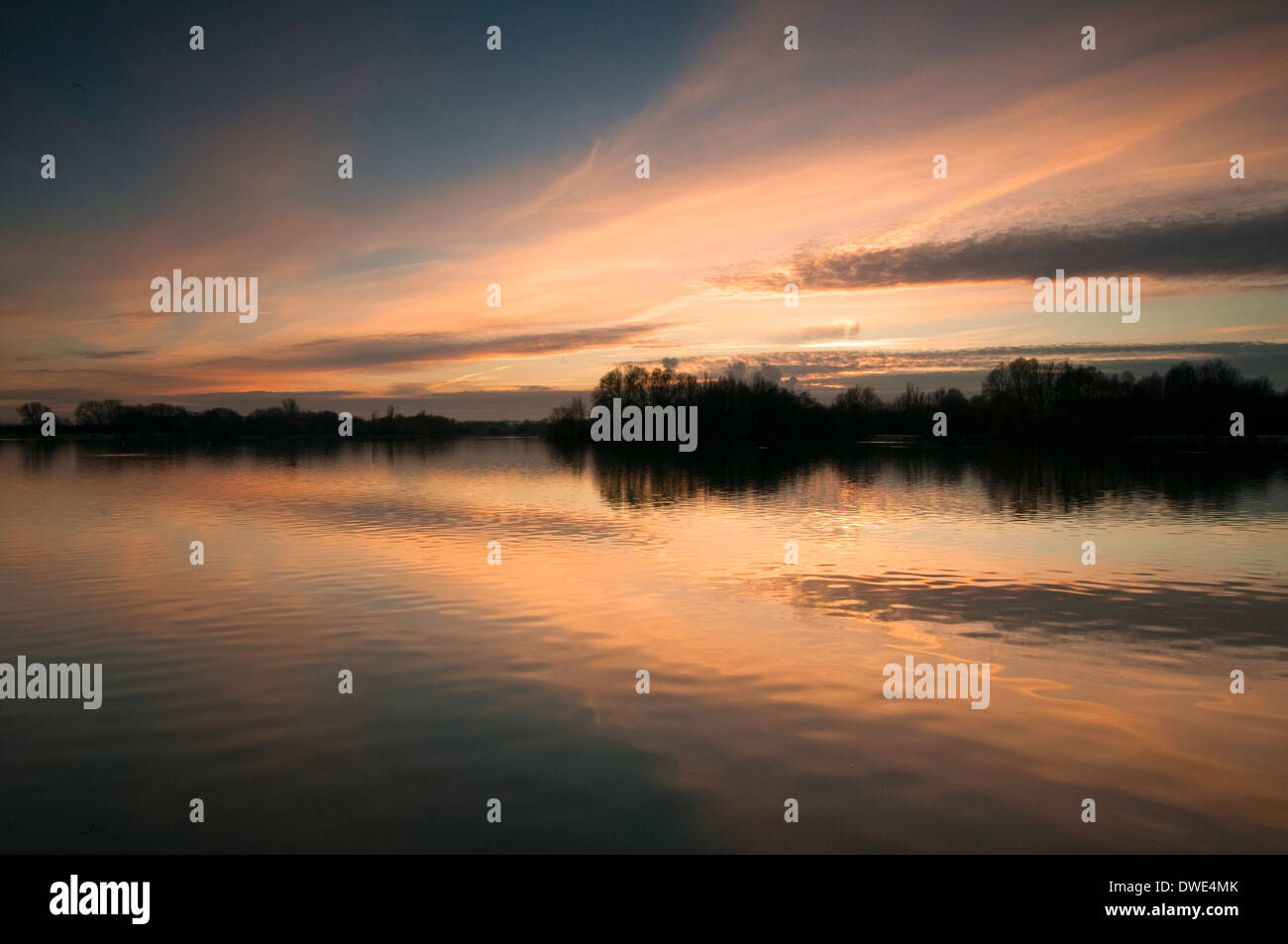 Sunrise reflected in the water at Colwick Park in Nottingham, England ...