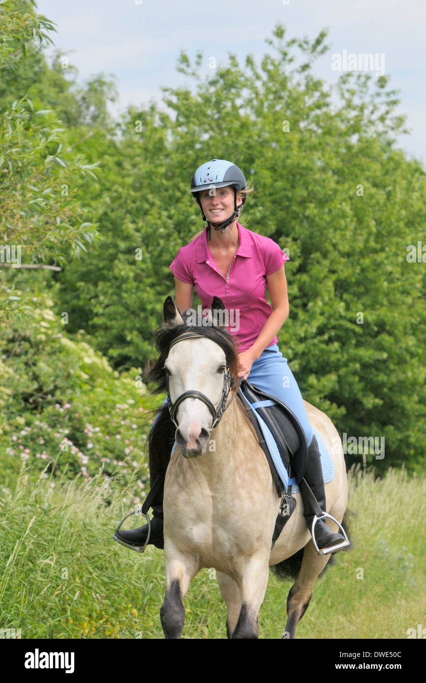 Dun rider riding gallop canter hi-res stock photography and images - Alamy