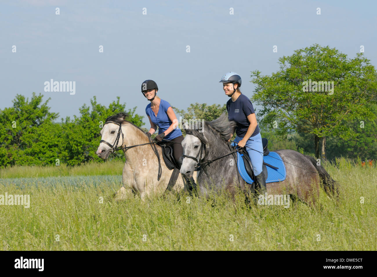 Two young women riding ponies hi-res stock photography and images - Alamy