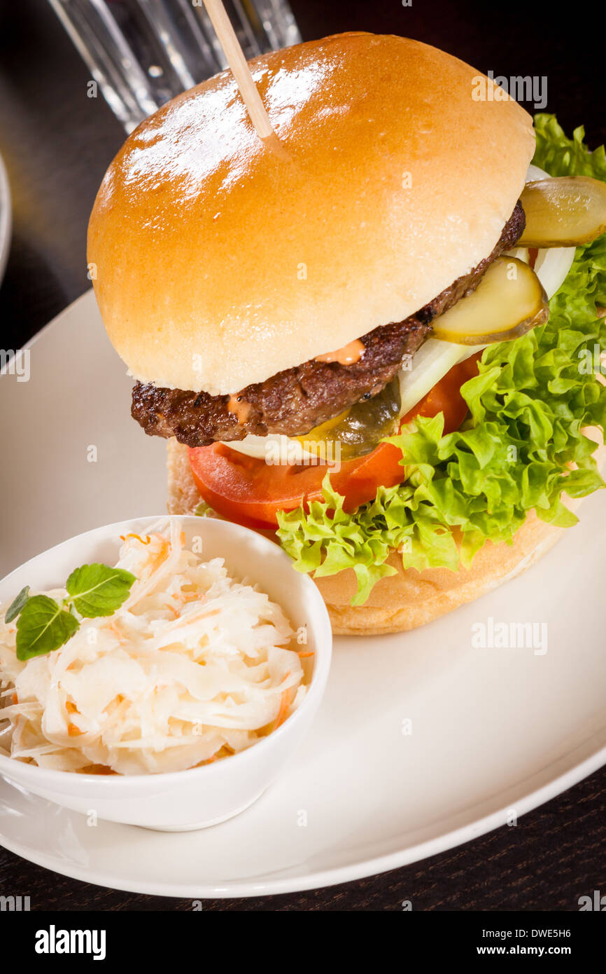 Tasty traditional cheeseburger with a ground beef patty topped with ...