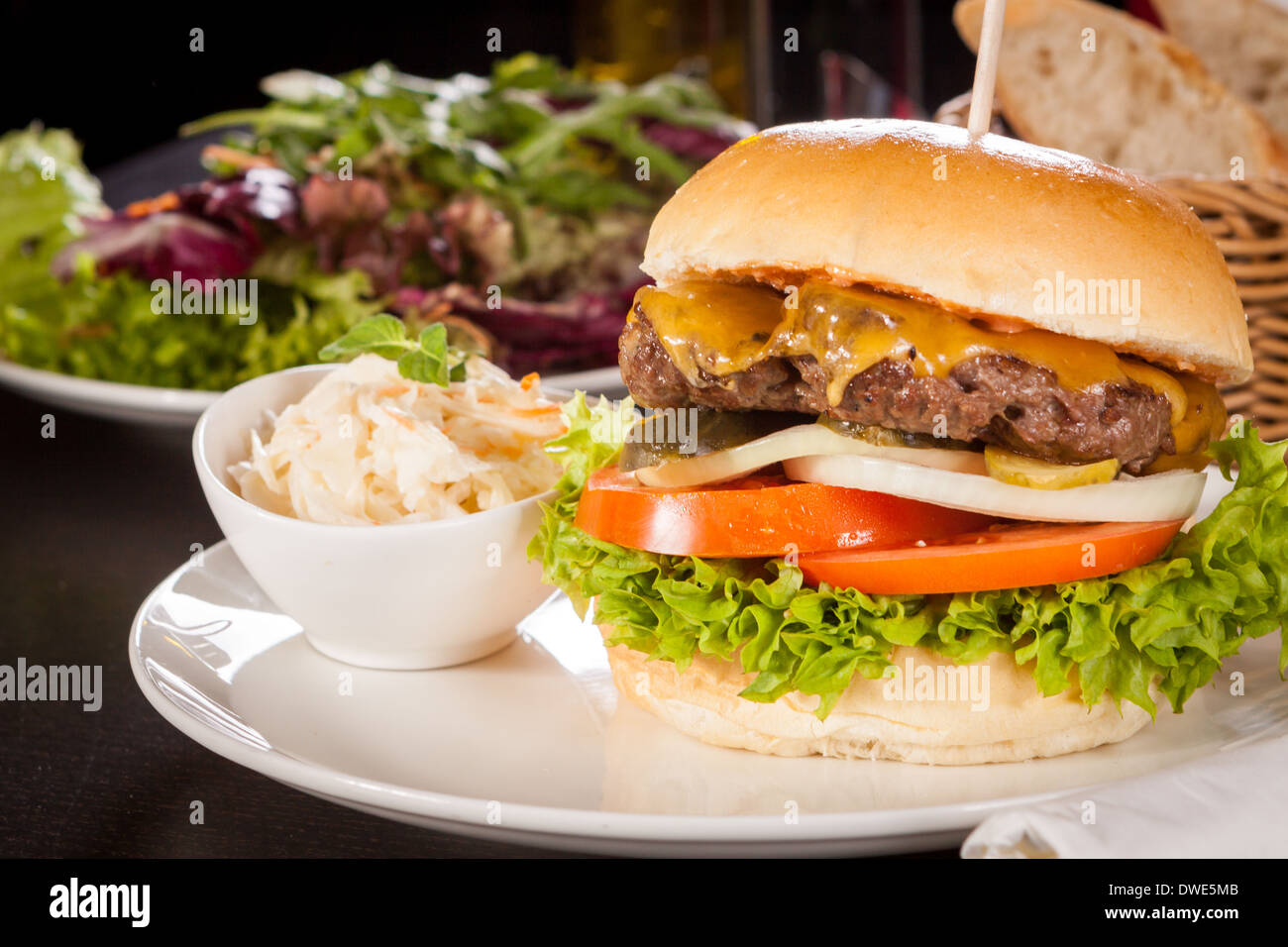 Tasty traditional cheeseburger with a ground beef patty topped with ...