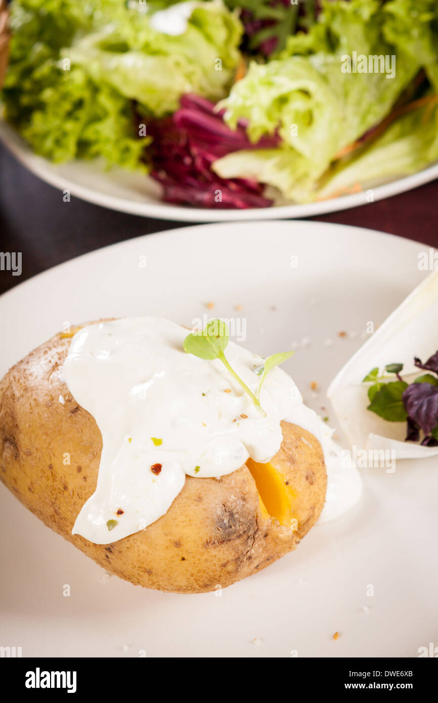 Overhead view of a healthy oven baked jacket potato with sour cream ...