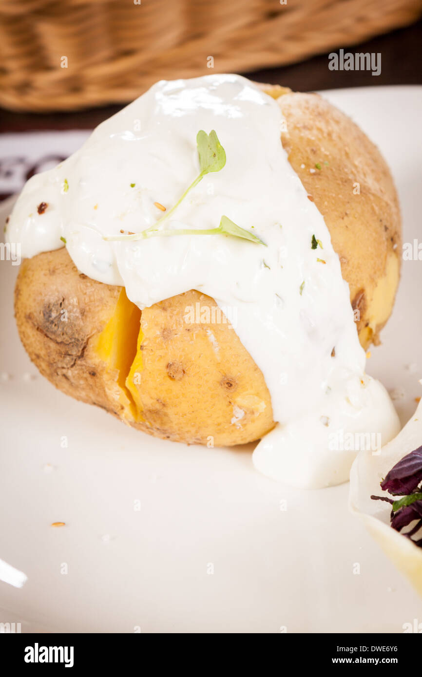 Overhead view of a healthy oven baked jacket potato with sour cream ...