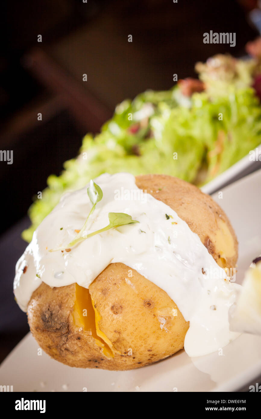Overhead view of a healthy oven baked jacket potato with sour cream ...