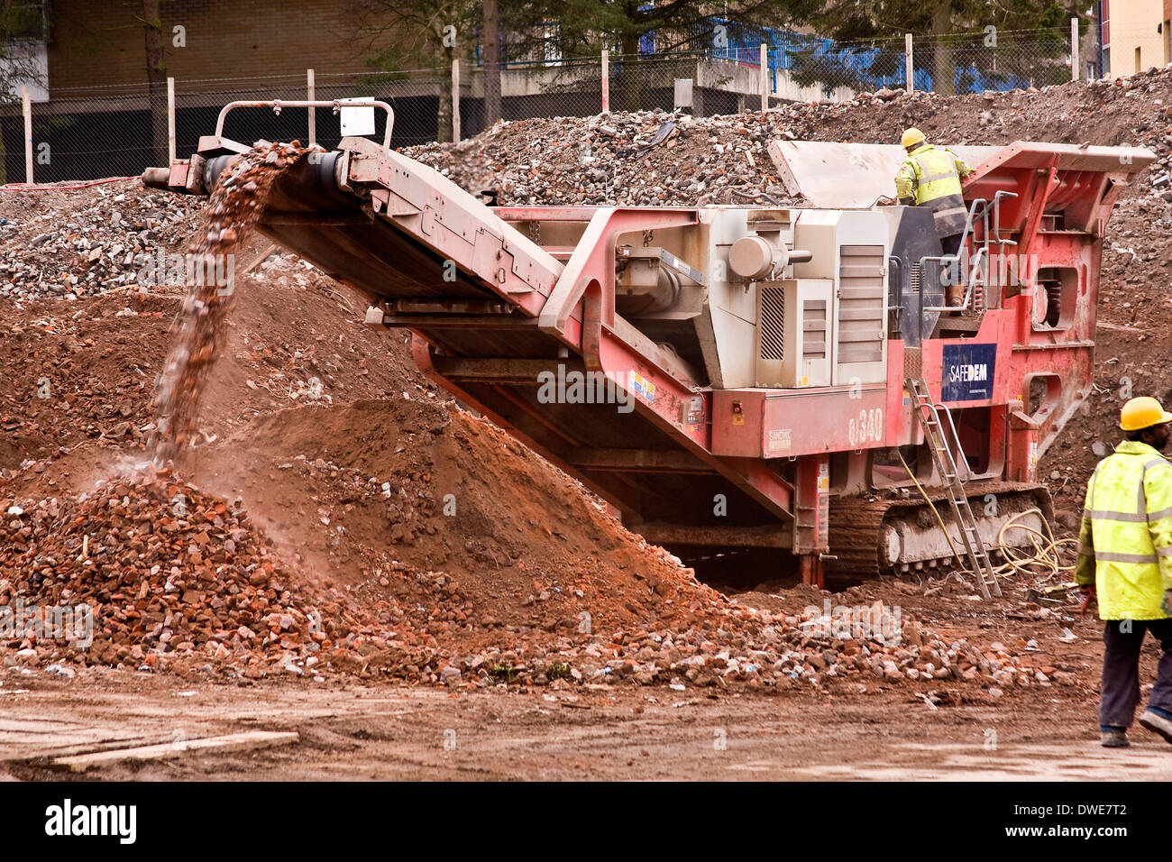 Safedem machines clearing up piles of rubble after the demolition of ...