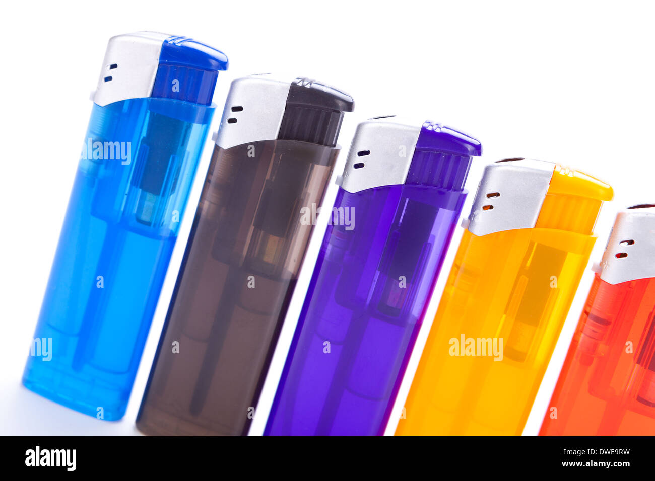 Row of vividly coloured plastic disposable lighters for smokers in red ...