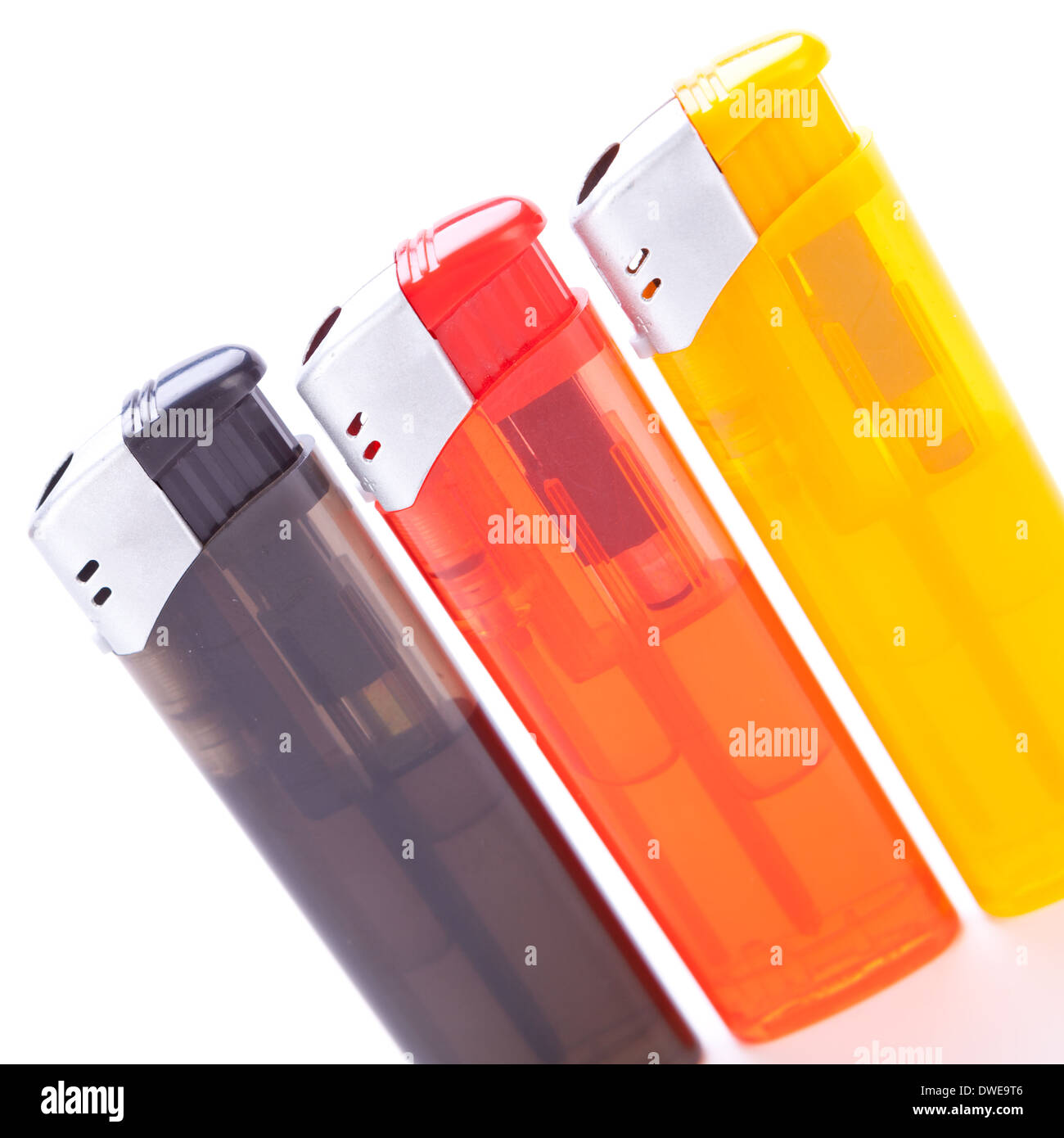Row of vividly coloured plastic disposable lighters for smokers in red ...