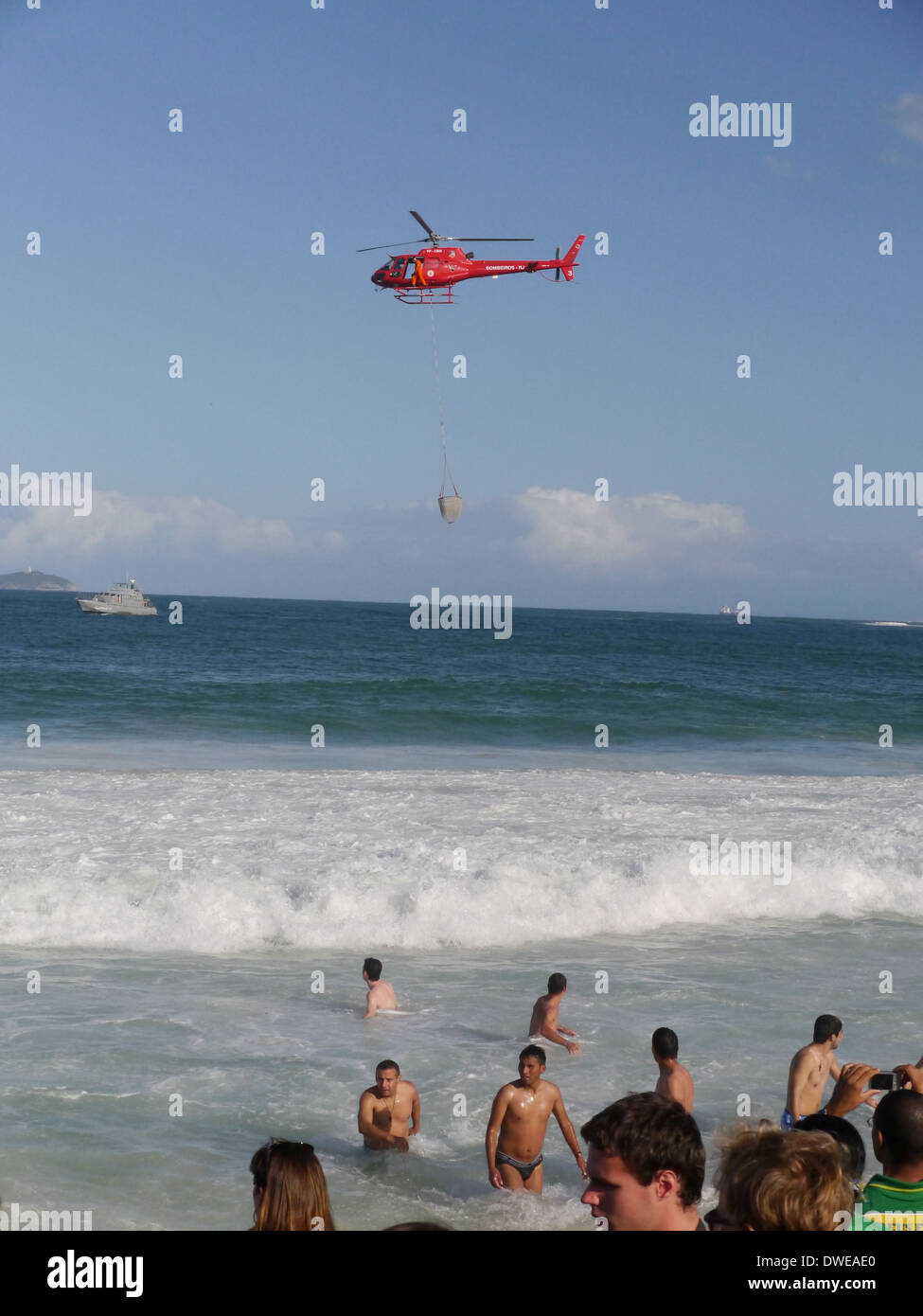 Helicopter rescuing people from the rough seas of Copacabana Beach ...