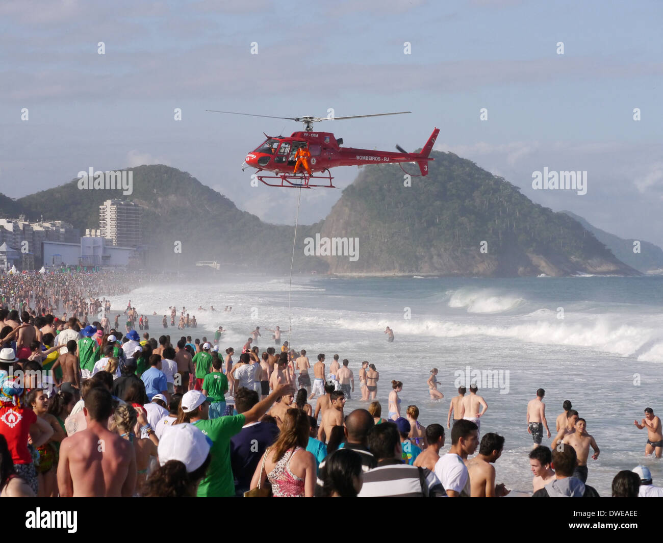 Helicopter rescuing people from the rough seas of Copacabana Beach ...