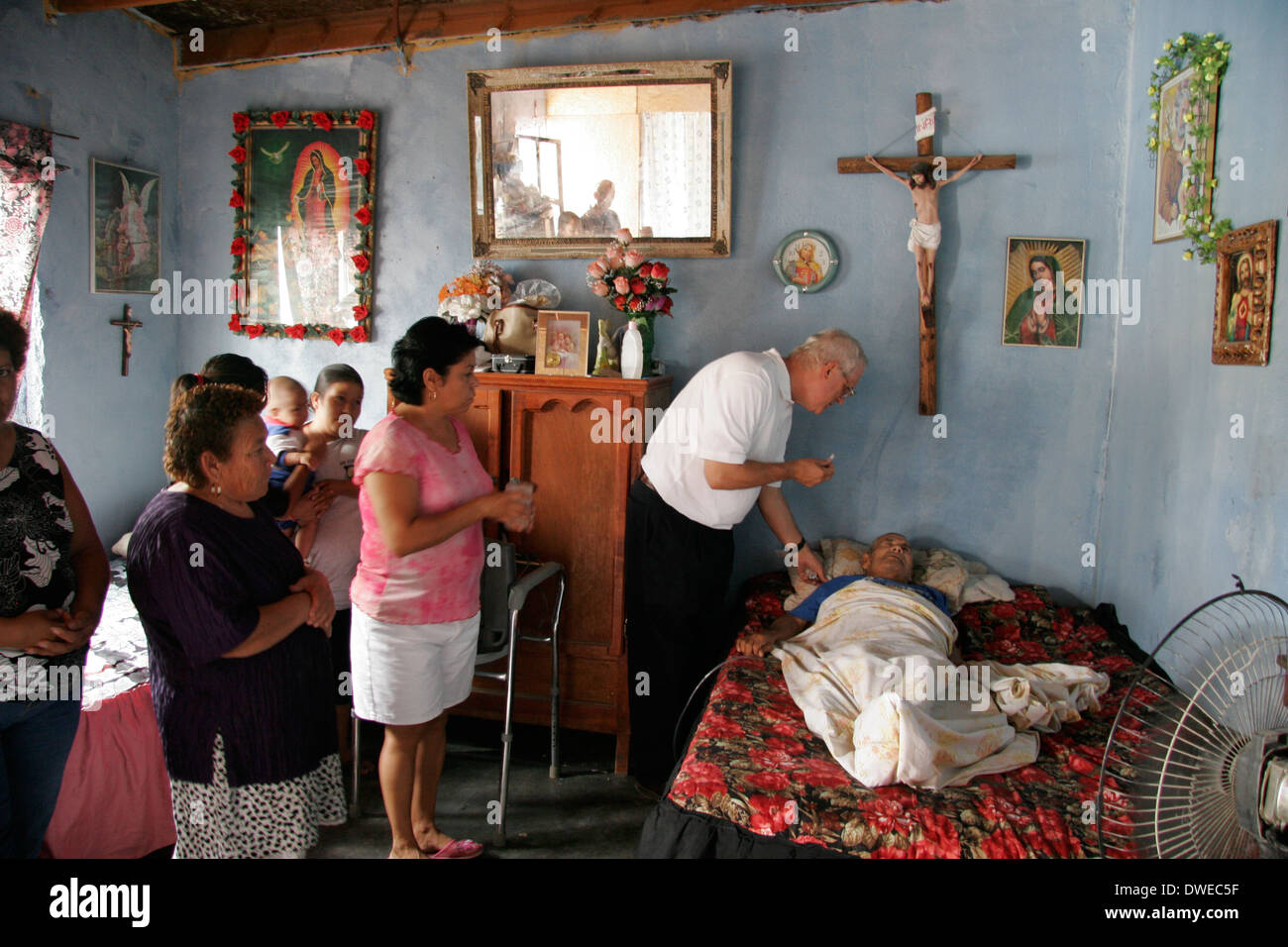 American Catholic missionary priest visiting dying man of Juarez ...