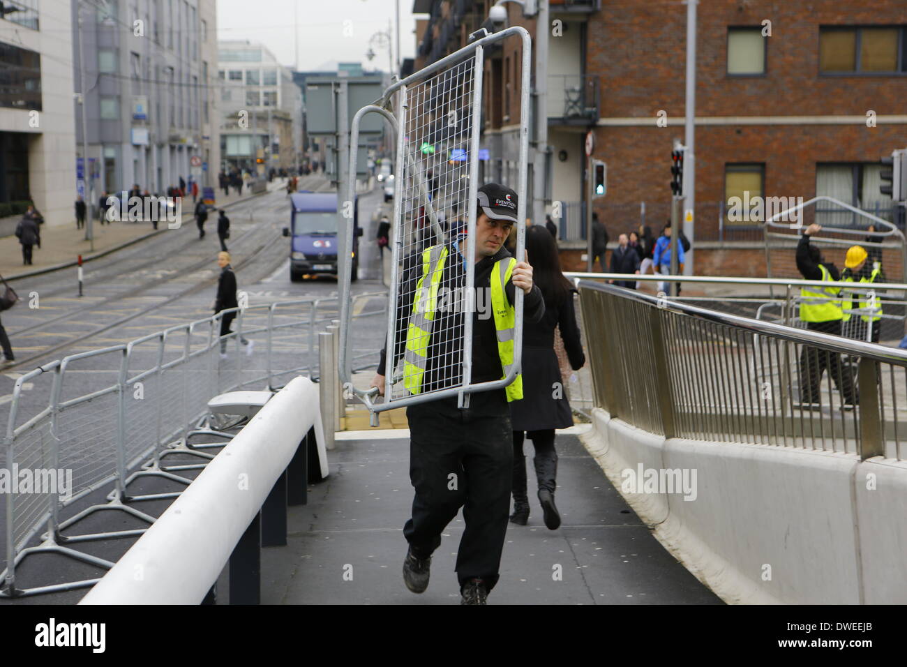 Dublin, Ireland. 6th March 2014. A worker carries a metal barrier which ...