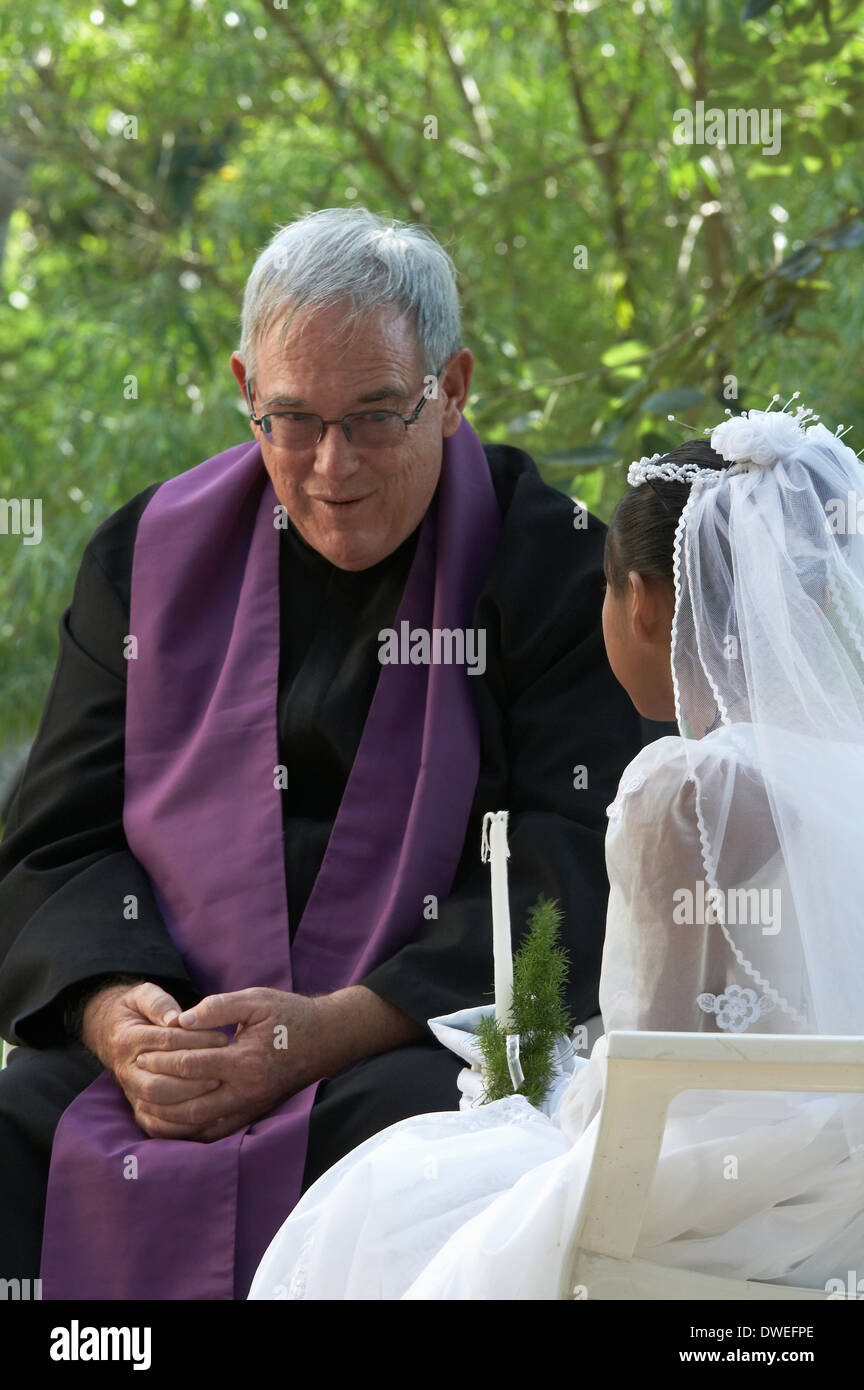 GUATEMALA American Catholic missionary priest in the Peten giving young ...