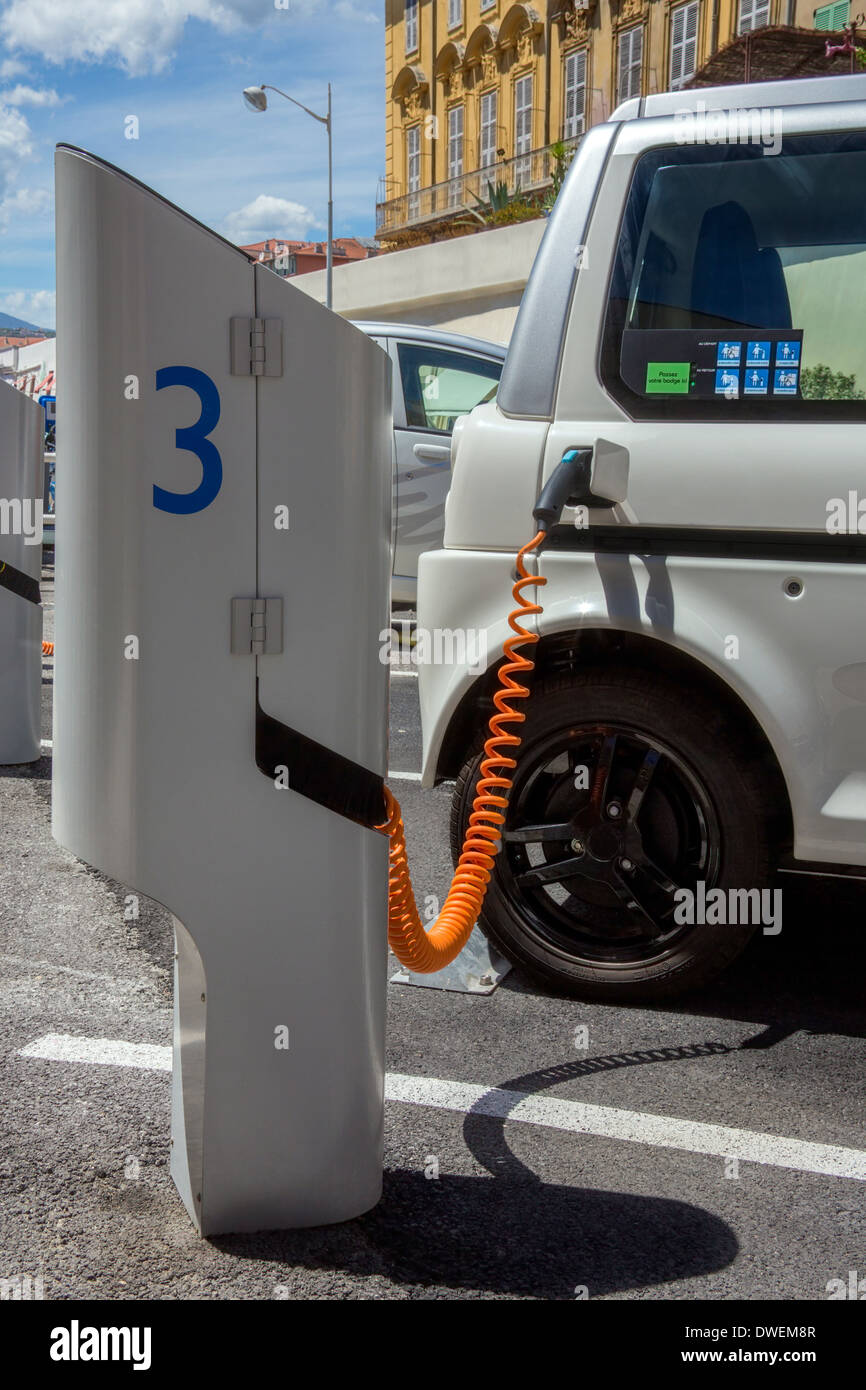 An eco-friendly car powered by electricity at a charging point on a ...