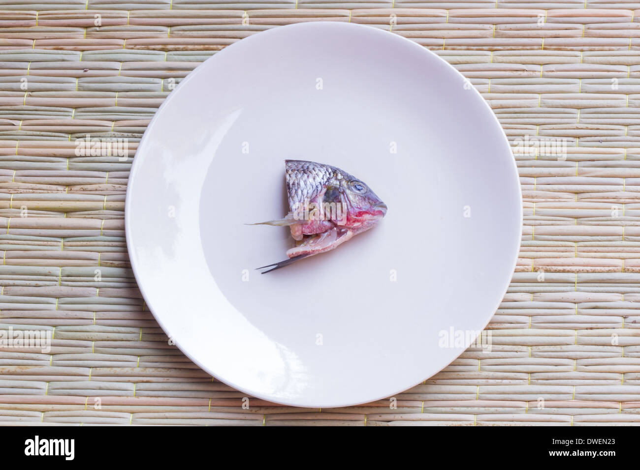 small fish's head in a big grey dish on a traditional mat Stock Photo ...