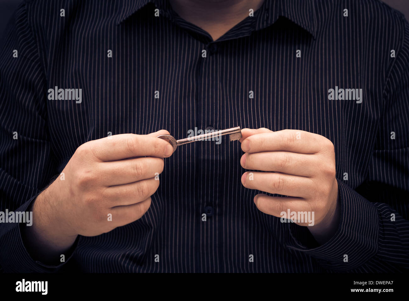 Man holding an old key in hand Stock Photo - Alamy