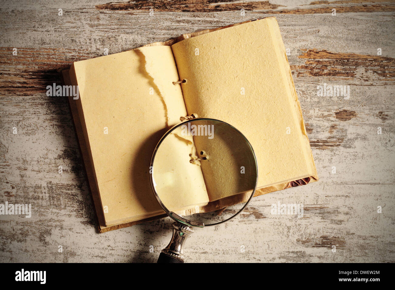 old notebook and magnifying glass Stock Photo - Alamy