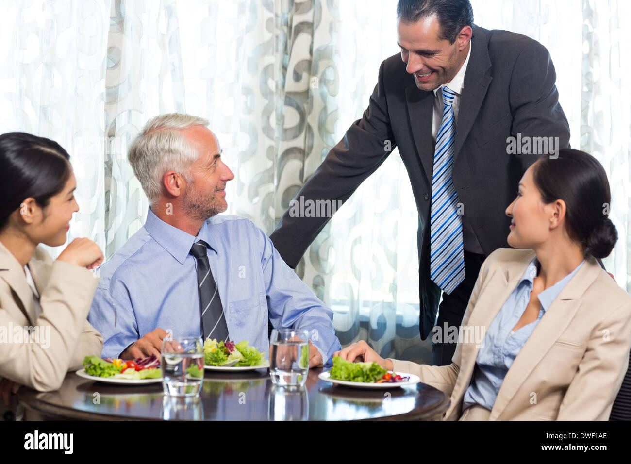 Business colleagues having meal Stock Photo - Alamy
