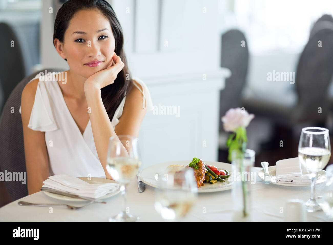 Beautiful smiling young woman at meal table Stock Photo - Alamy