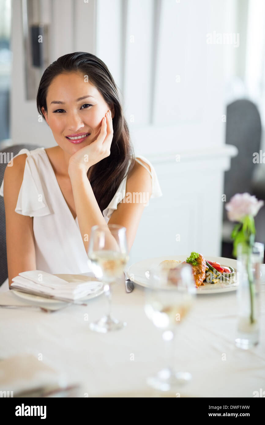 Beautiful smiling young woman at meal table Stock Photo - Alamy