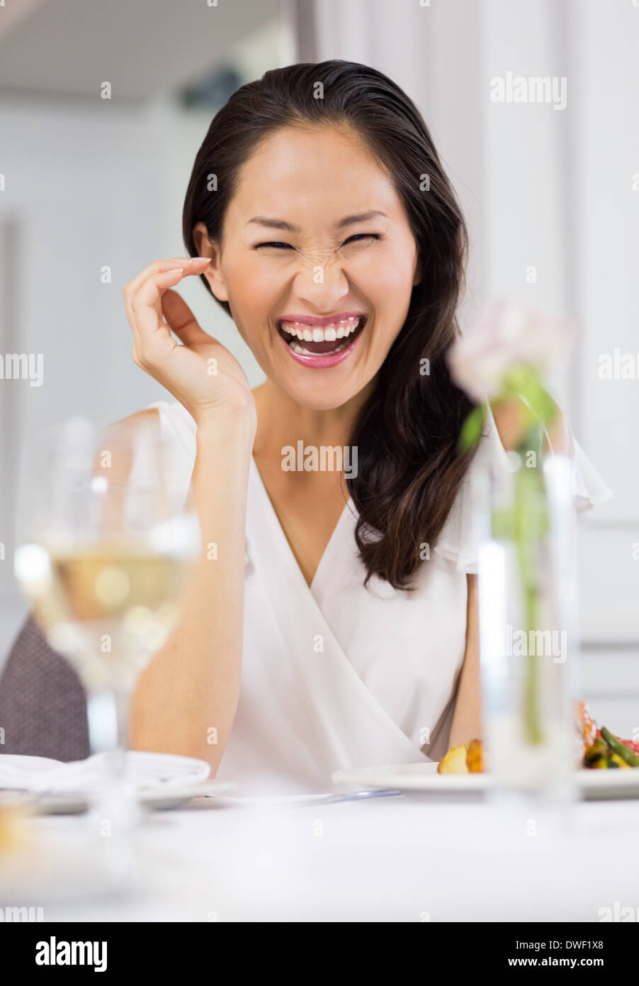 Portrait of a laughing woman at meal table Stock Photo - Alamy