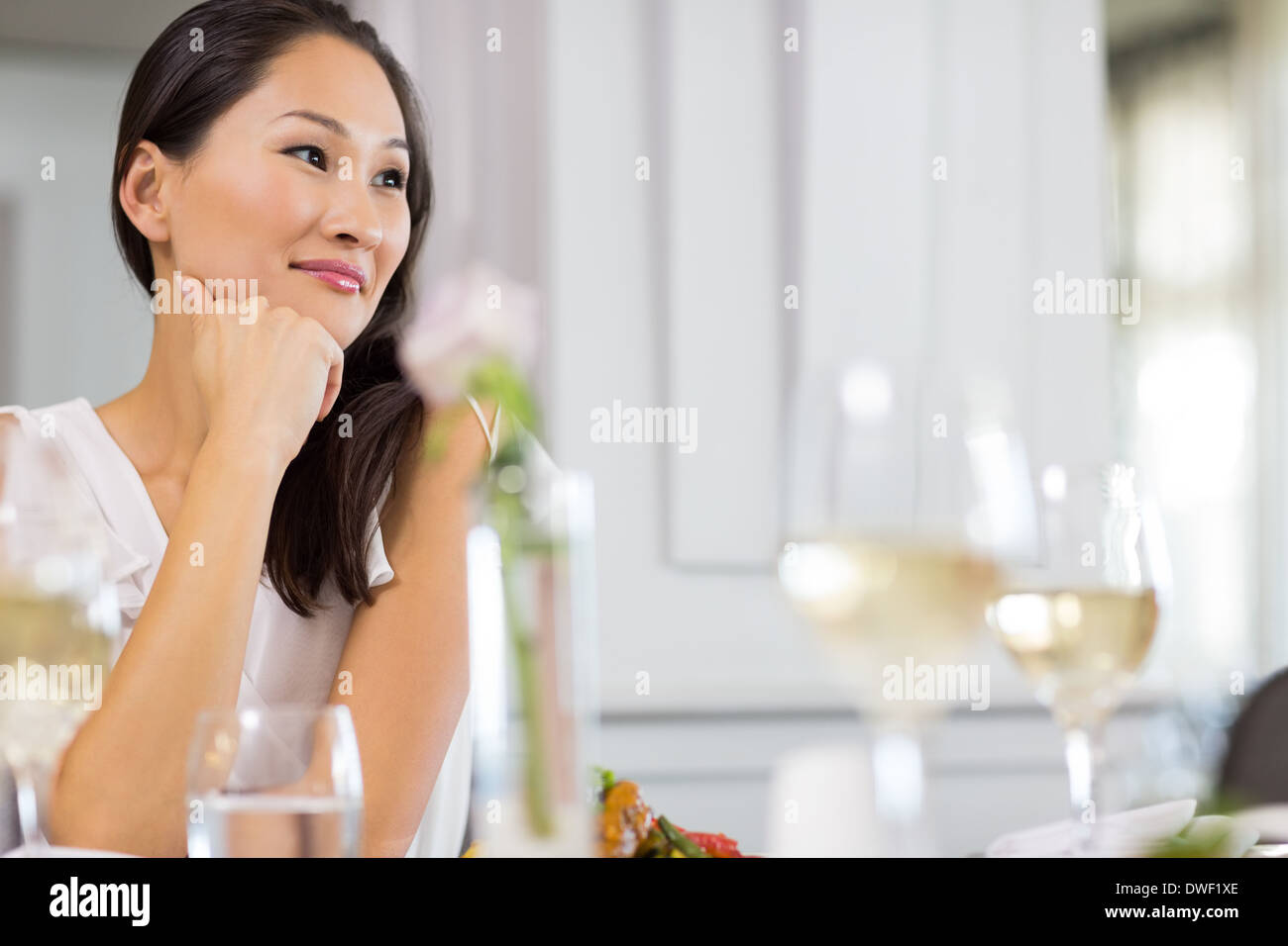 Thoughtful beautiful woman at meal table Stock Photo - Alamy