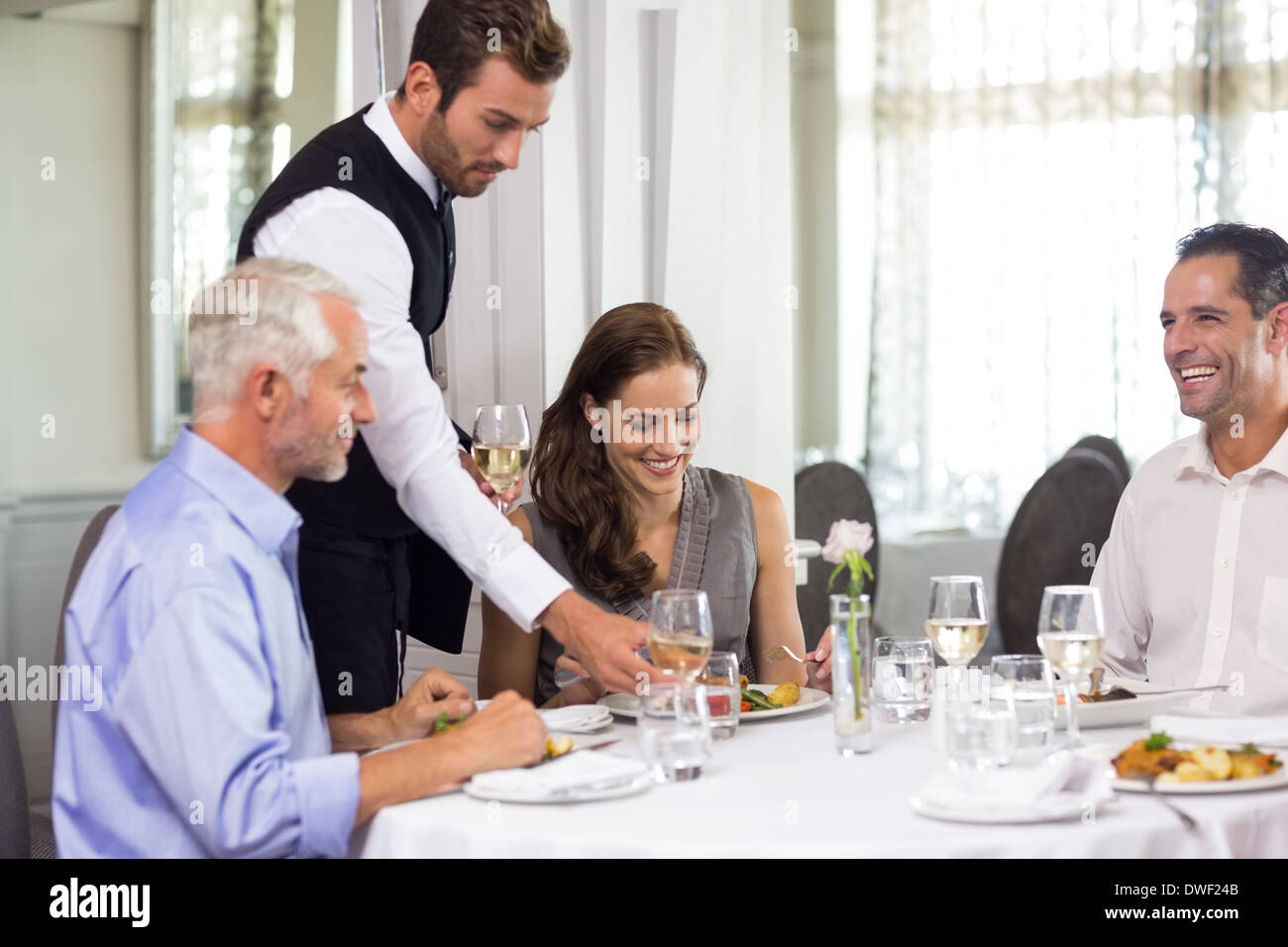 Business colleagues around dining table in restaurant Stock Photo - Alamy