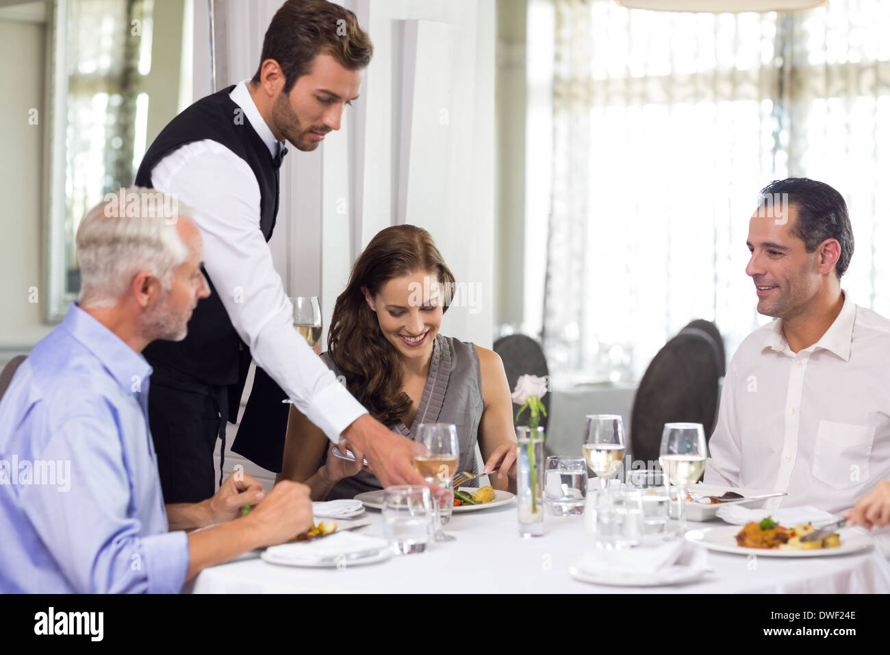 Business colleagues around dining table in restaurant Stock Photo - Alamy