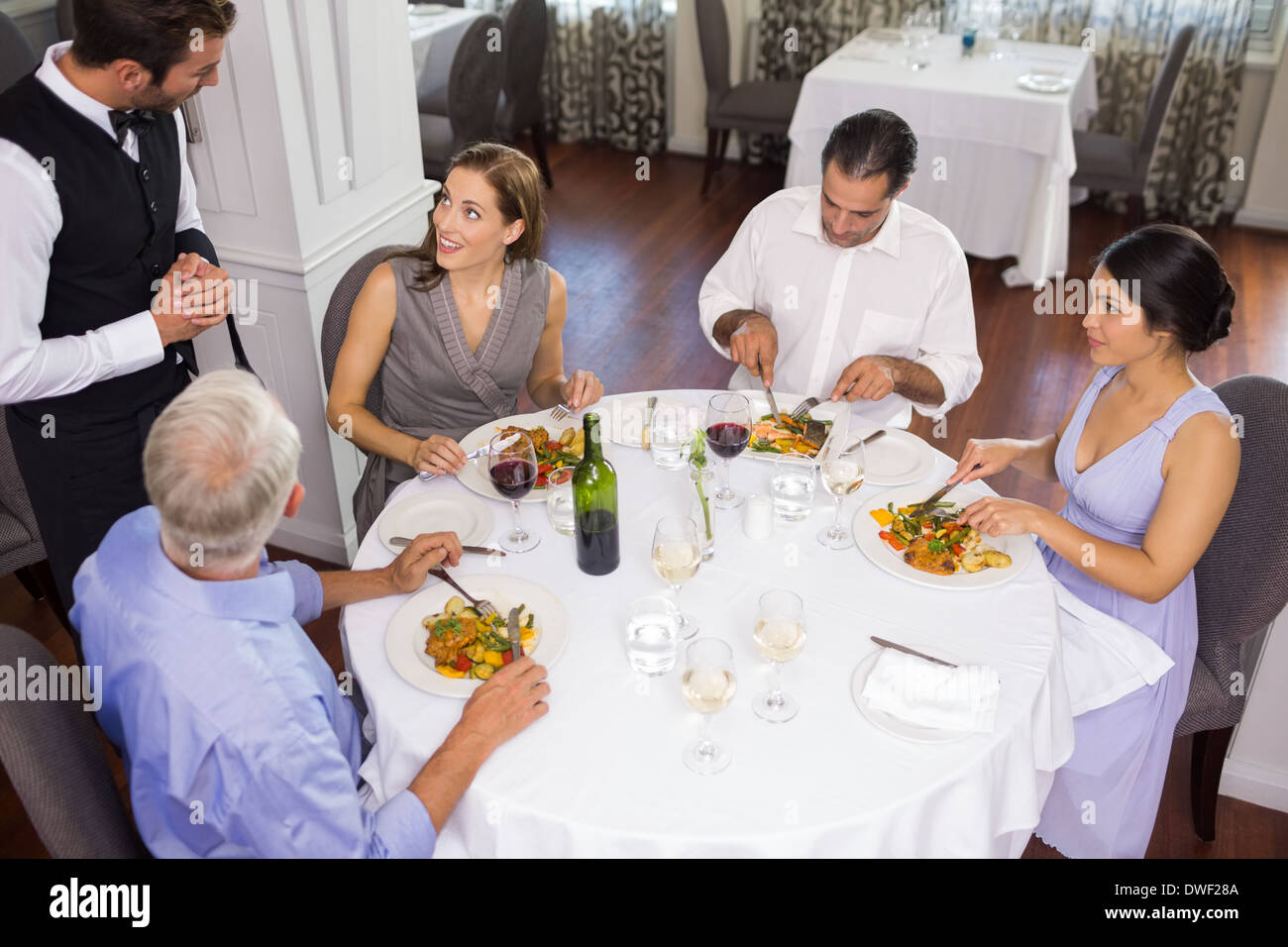 Business colleagues around dining table in restaurant Stock Photo - Alamy