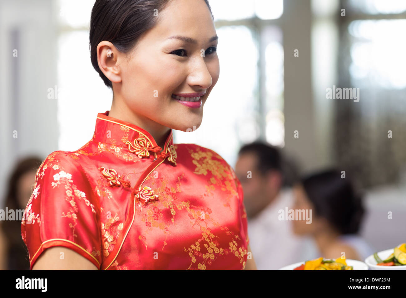 Waitress carrying food tray with people in restaurant Stock Photo - Alamy