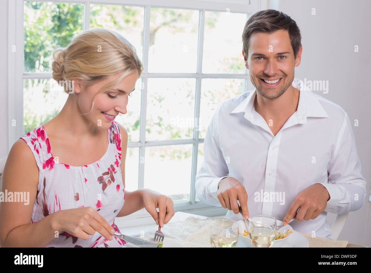 Portrait of a happy couple having food Stock Photo - Alamy