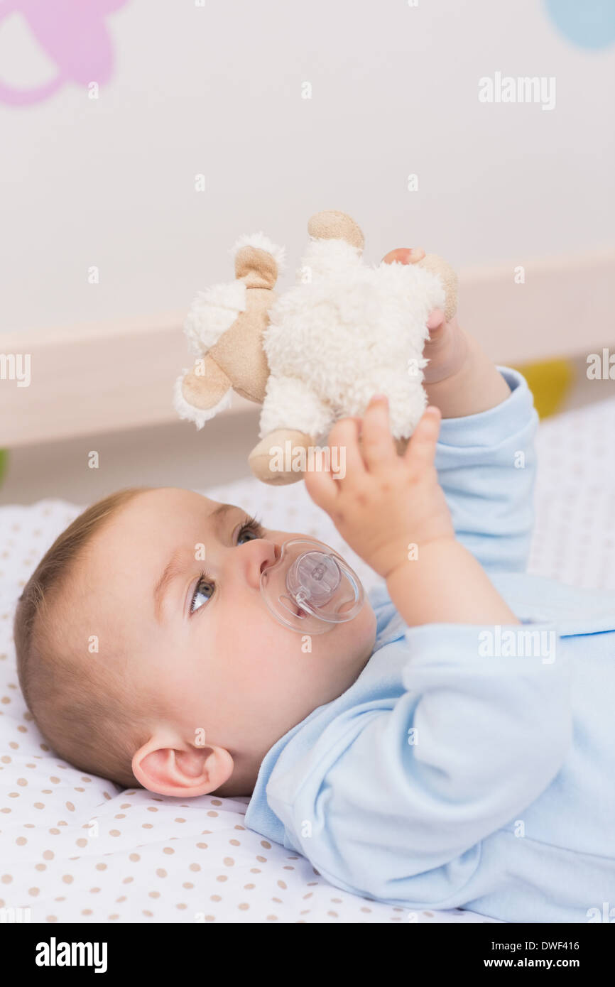 Baby playing with teddy bear Stock Photo - Alamy