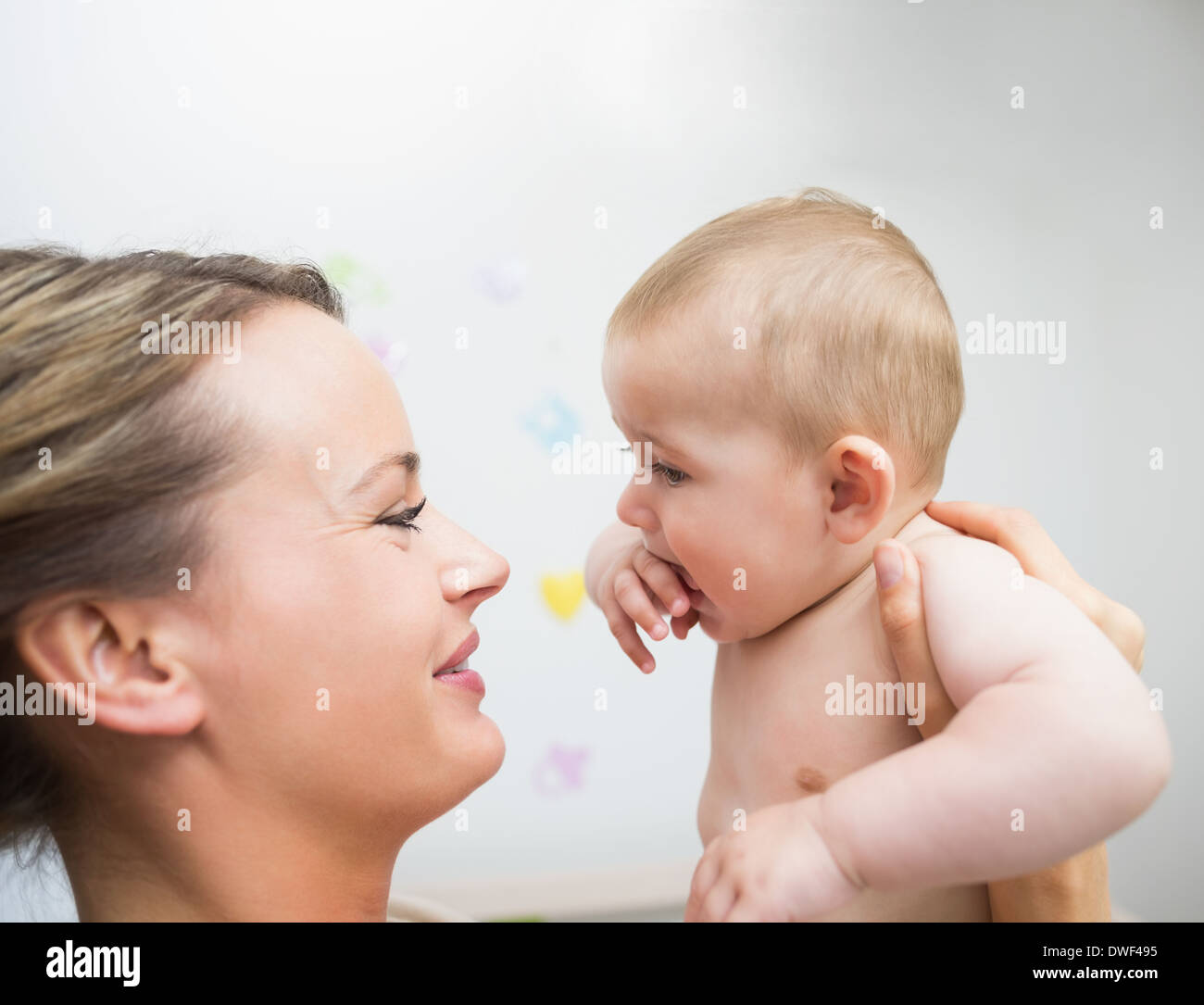 Loving mother carrying baby Stock Photo - Alamy