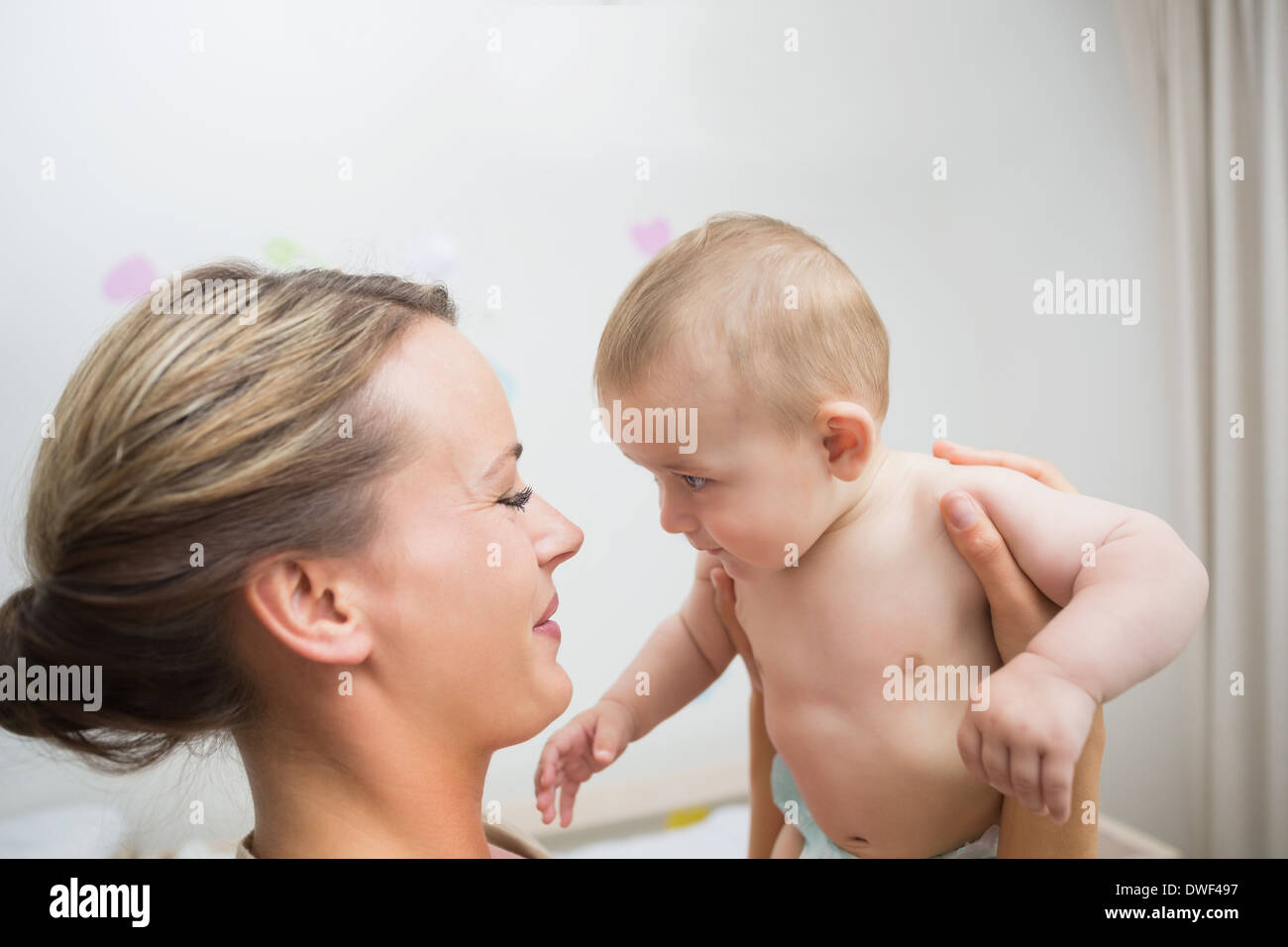 Caring mother carrying baby Stock Photo - Alamy