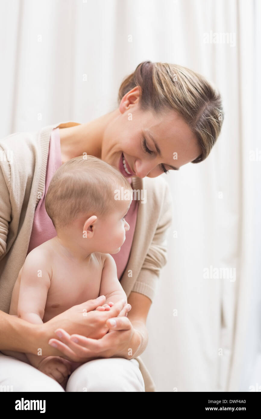 Mother looking at baby Stock Photo - Alamy