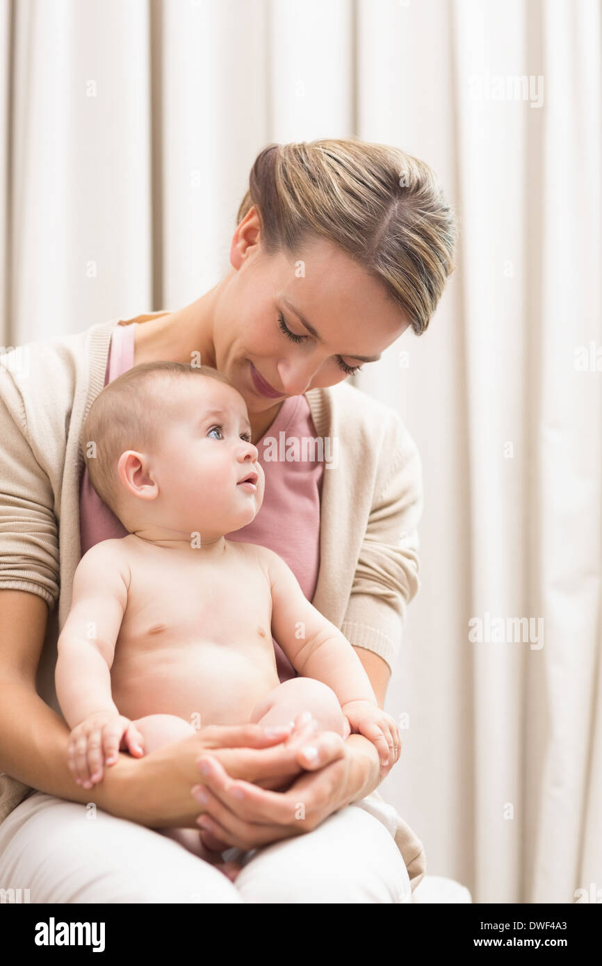 Baby sitting with mother at home Stock Photo - Alamy