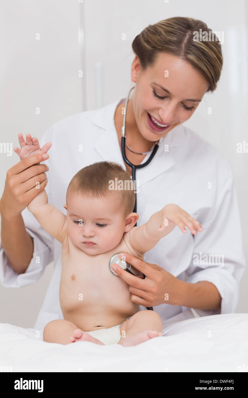 Female doctor checking baby Stock Photo - Alamy