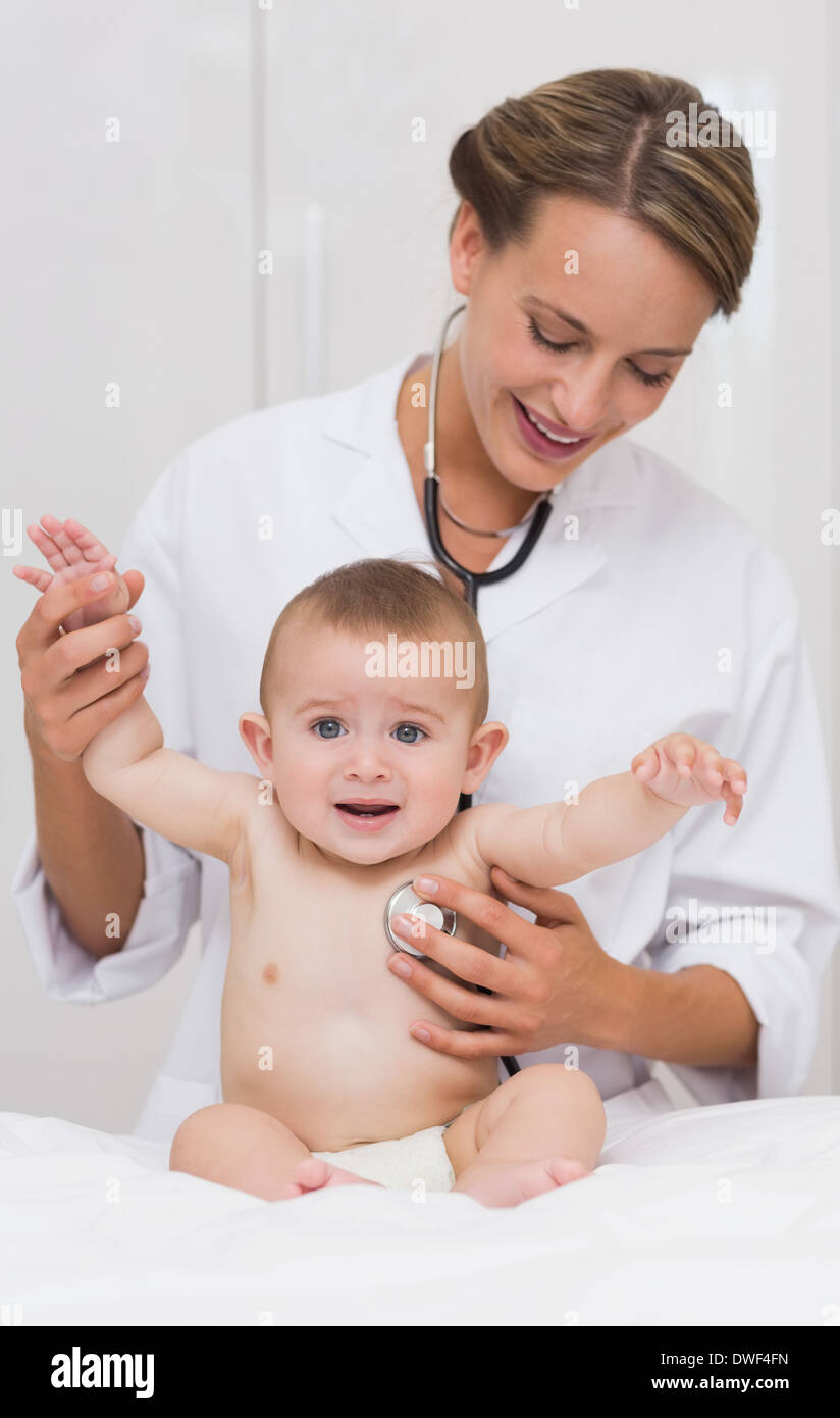 Smiling doctor checking baby boy Stock Photo - Alamy