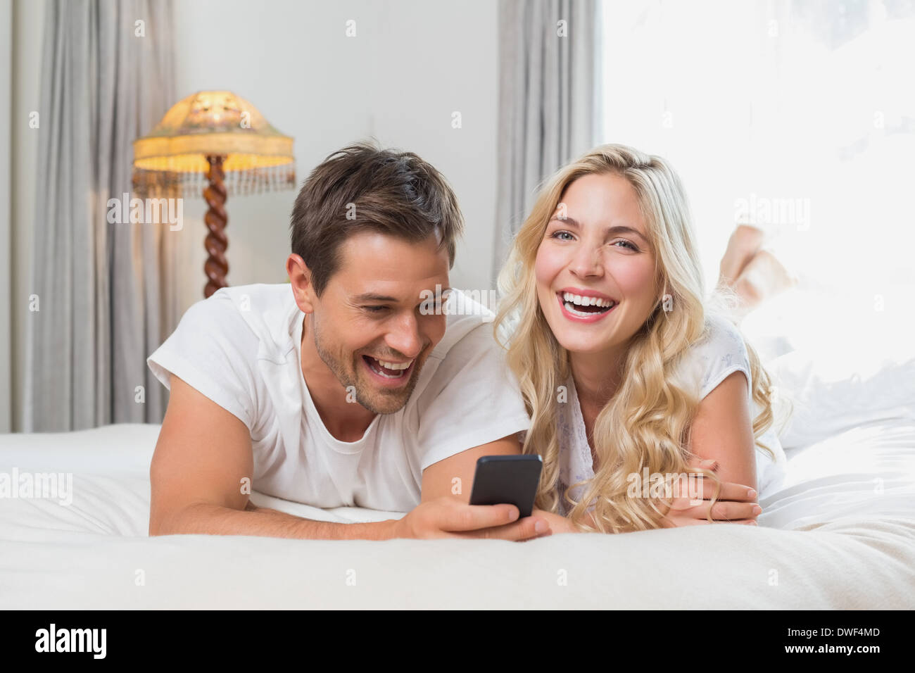 Couple texting in bed hi-res stock photography and images - Alamy