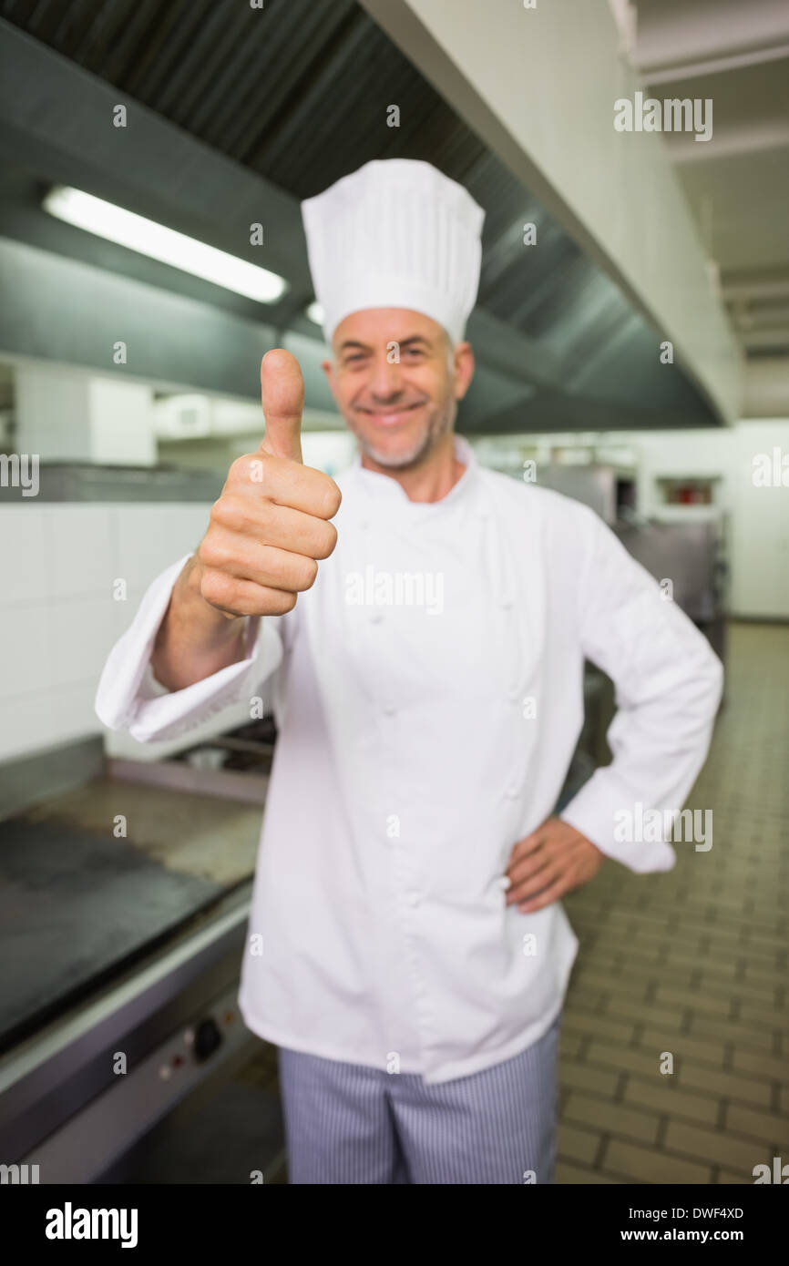 Happy chef looking at the camera giving thumbs up Stock Photo - Alamy