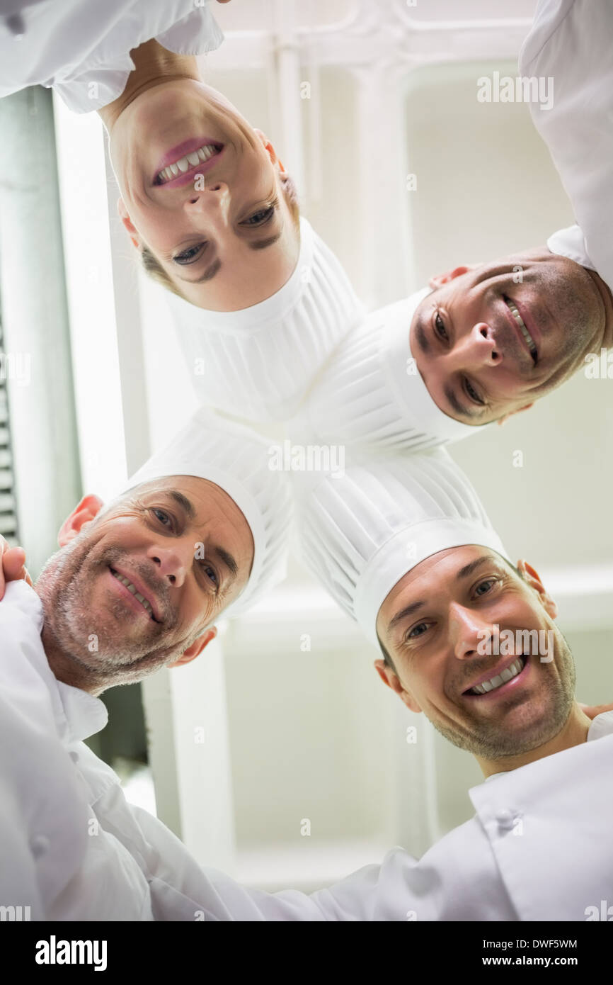 Happy team of chefs standing in a circle Stock Photo - Alamy