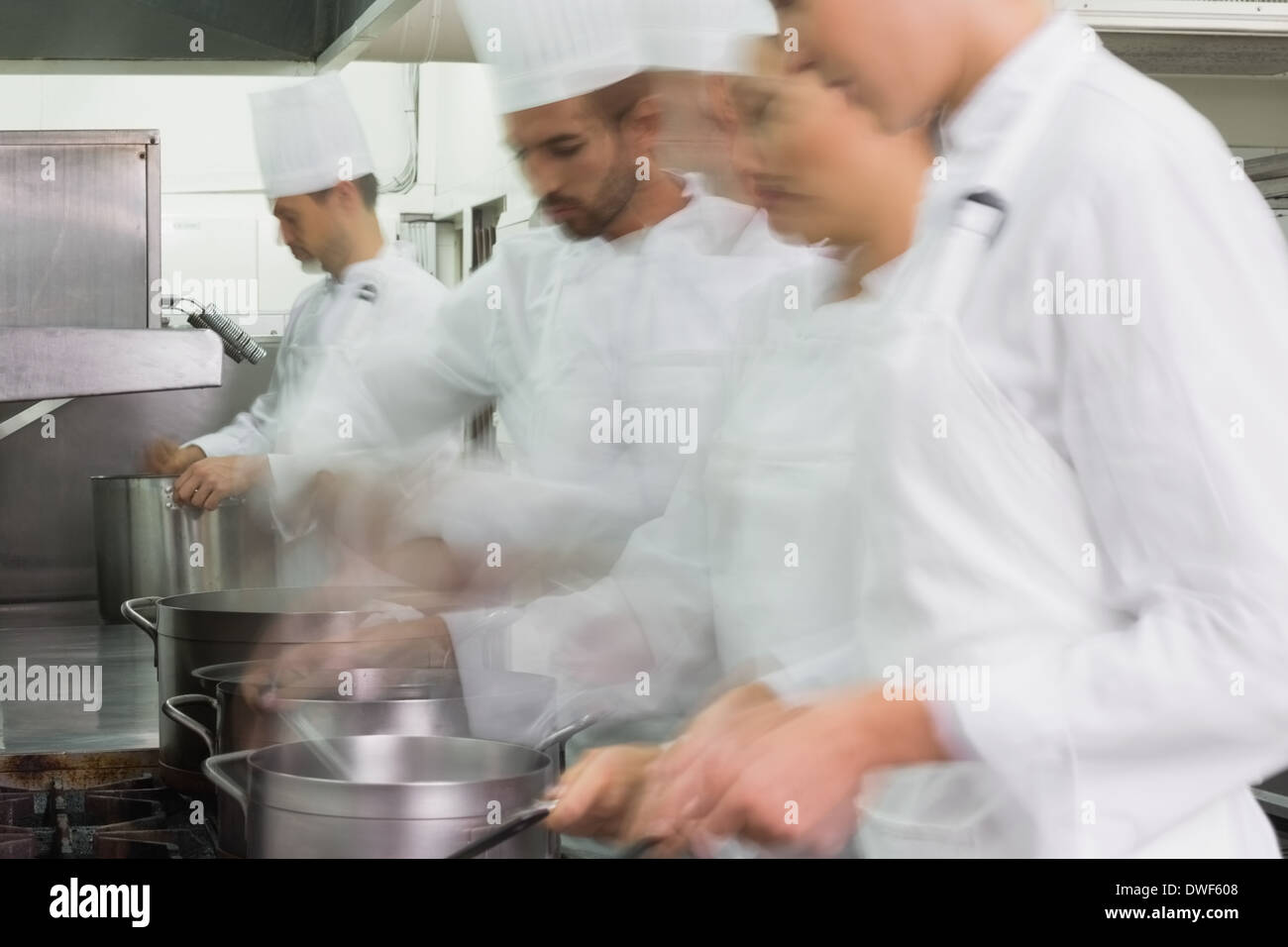 Busy team of chefs at work Stock Photo - Alamy
