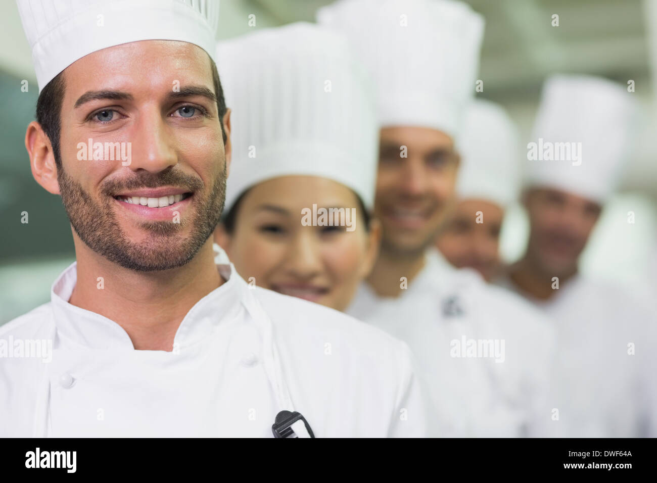 Happy team of chefs standing in line Stock Photo - Alamy